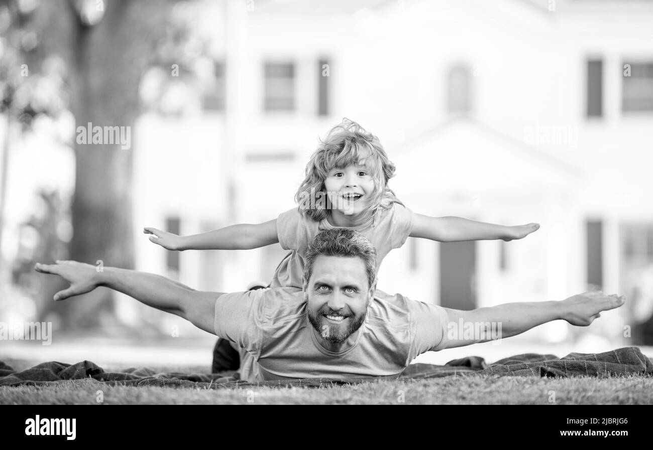 happy daddy having fun with child relax together on green park grass ...