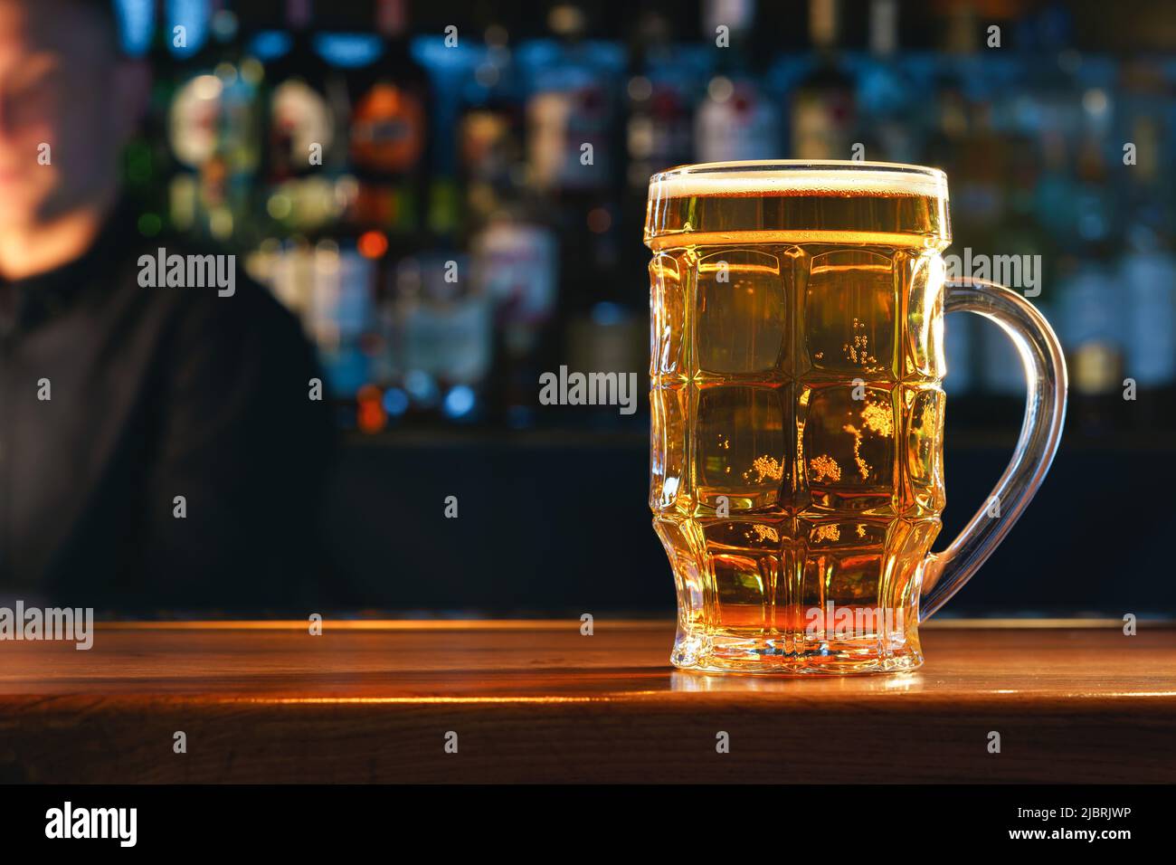 Fresh cold beer in glass on bar background Stock Photo - Alamy