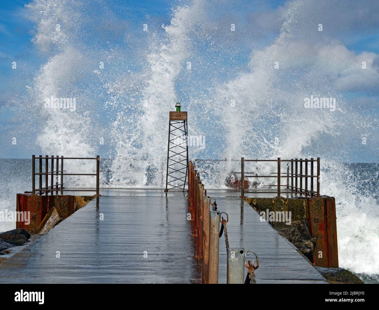Lighthouse in swell with splashing waves on the Danish North Sea coast ...