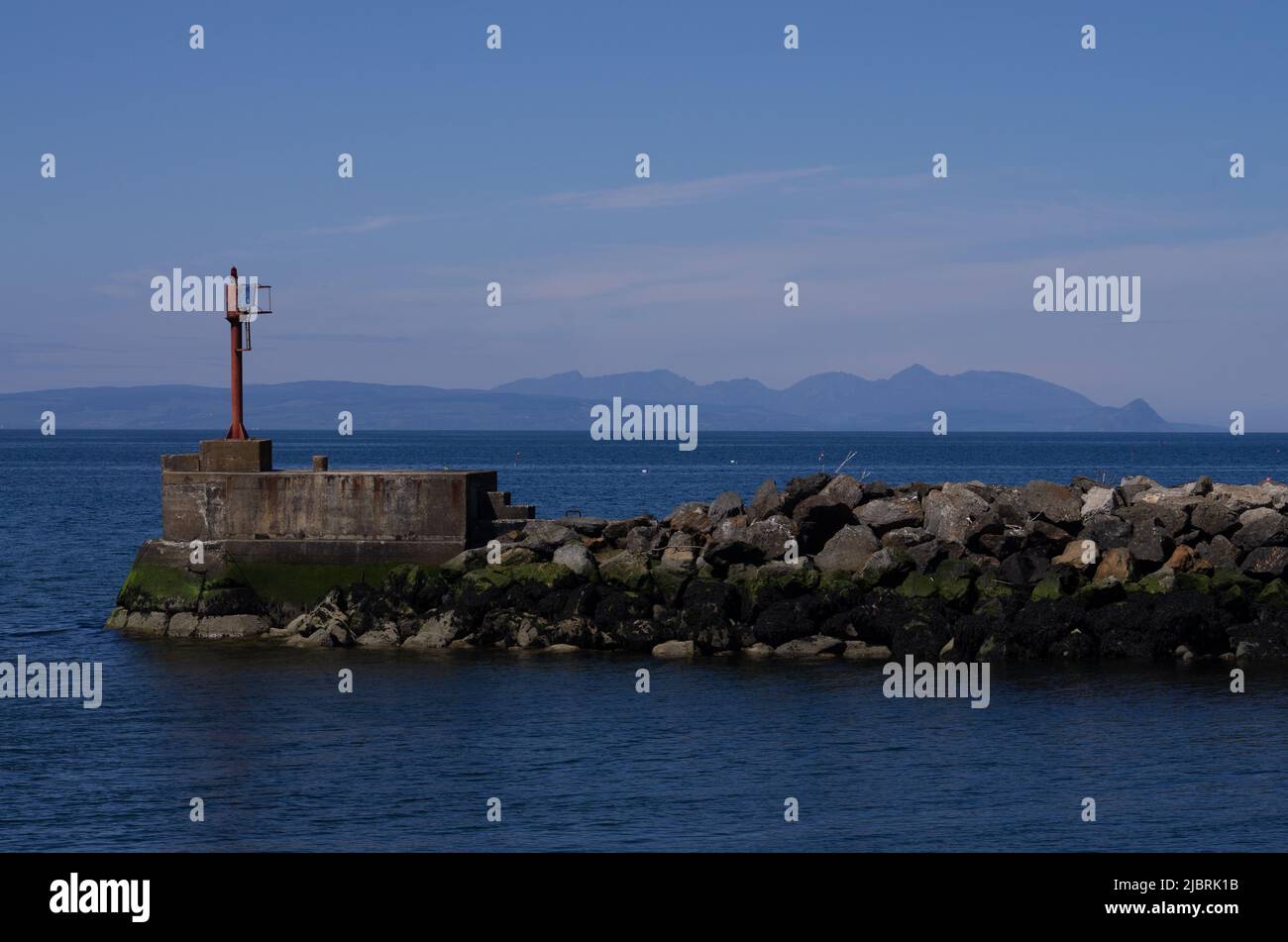 Girvan harbour wall with the Isle of Arran on the horizon Stock Photo ...