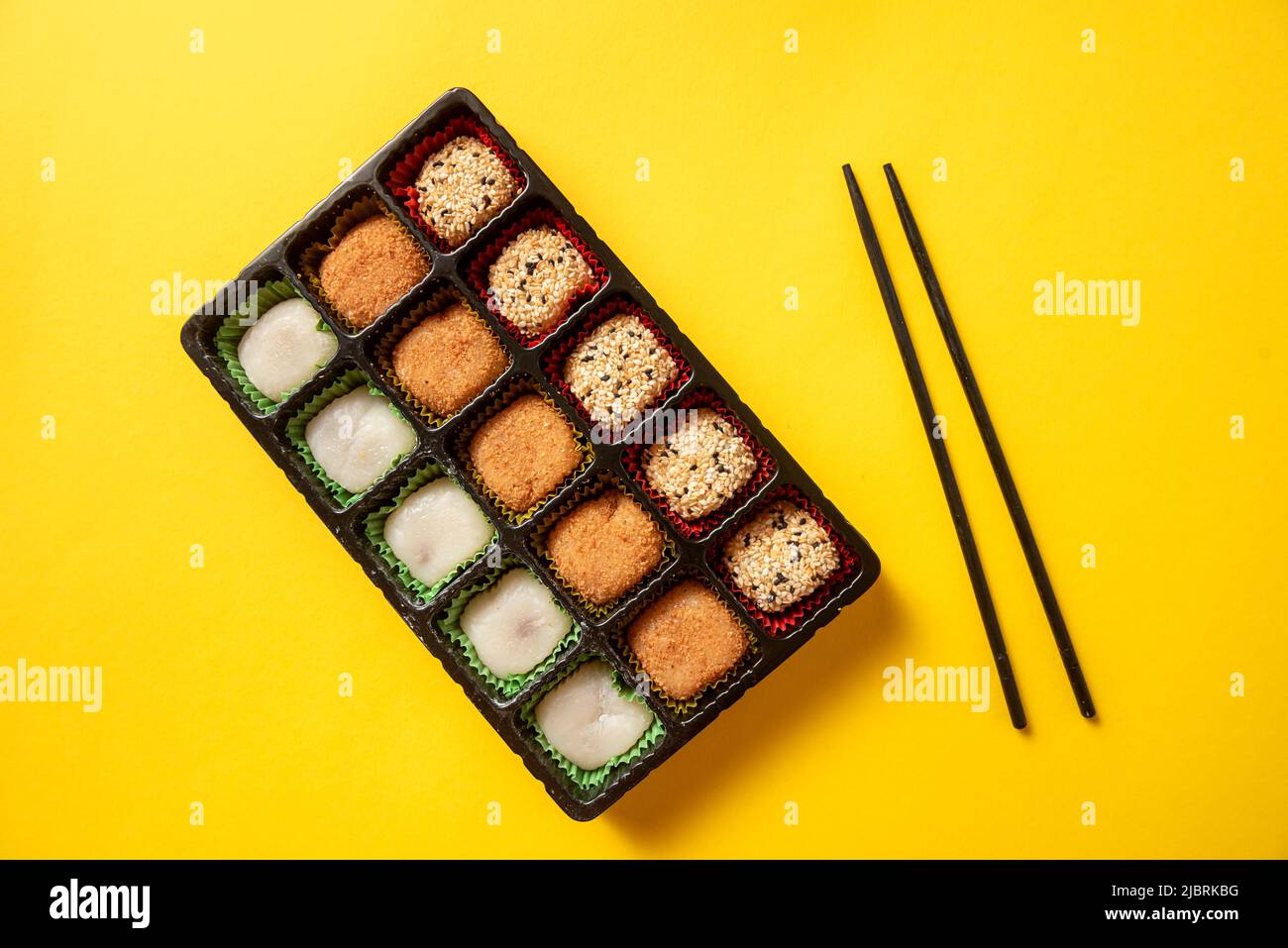 Japanese mochi dessert in a plastic box on a yellow background Stock ...