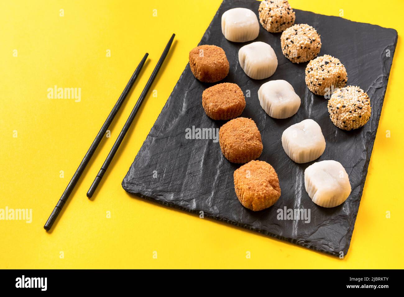 Asian sweets on the slate. Traditional Japanese dessert on a yellow ...
