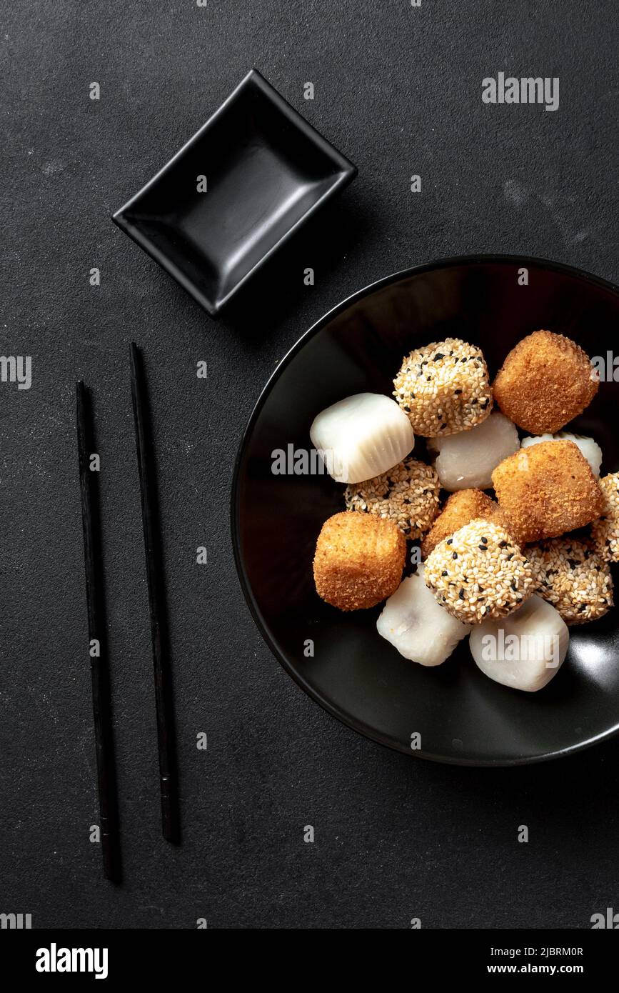 Many different delicious mochi on grey table, flat lay. Traditional ...
