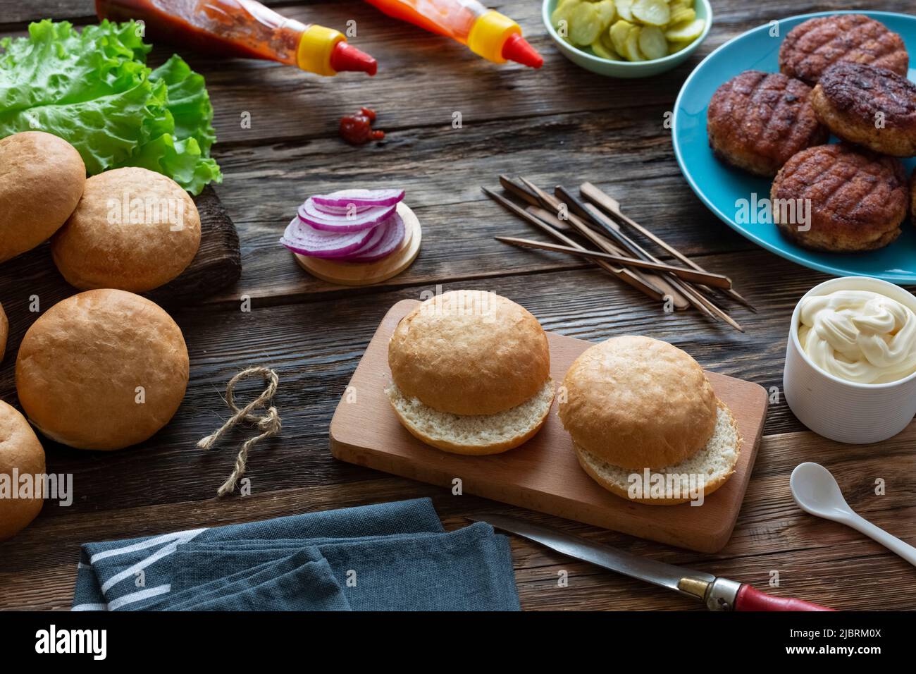 process of cooking delicious burgers with grilled meat cutlets, various ...