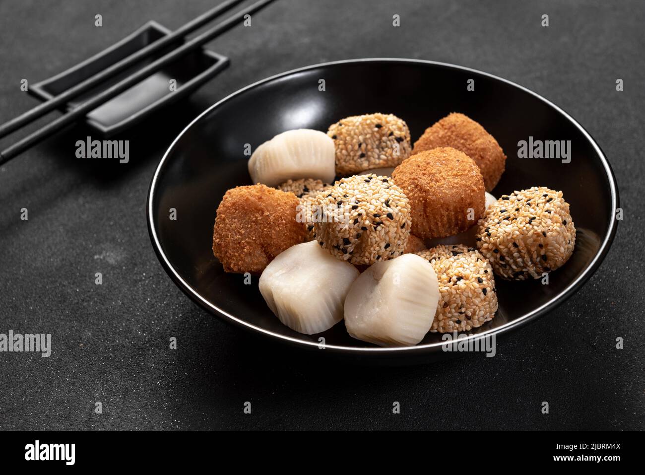 Many different delicious mochi on grey table, flat lay. Traditional ...