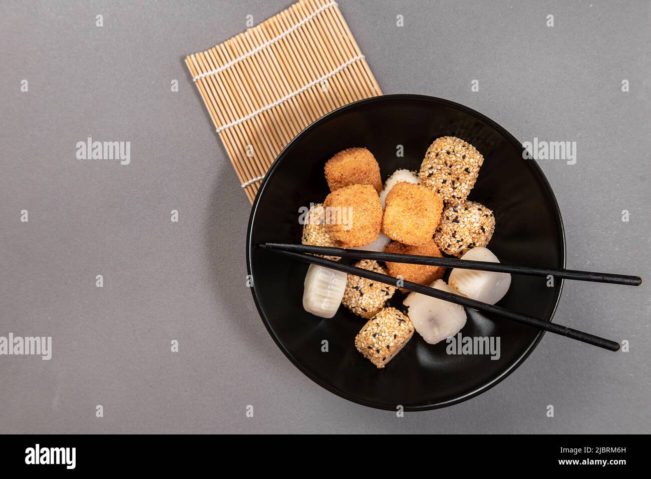 Many different delicious mochi on grey table, flat lay. Traditional ...