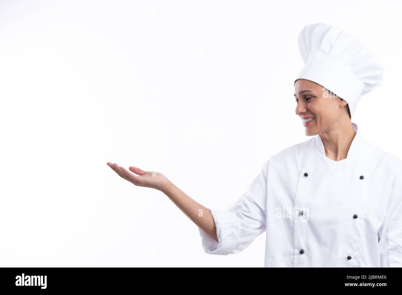 Woman chef with outstretched hand isolated on white background with ...