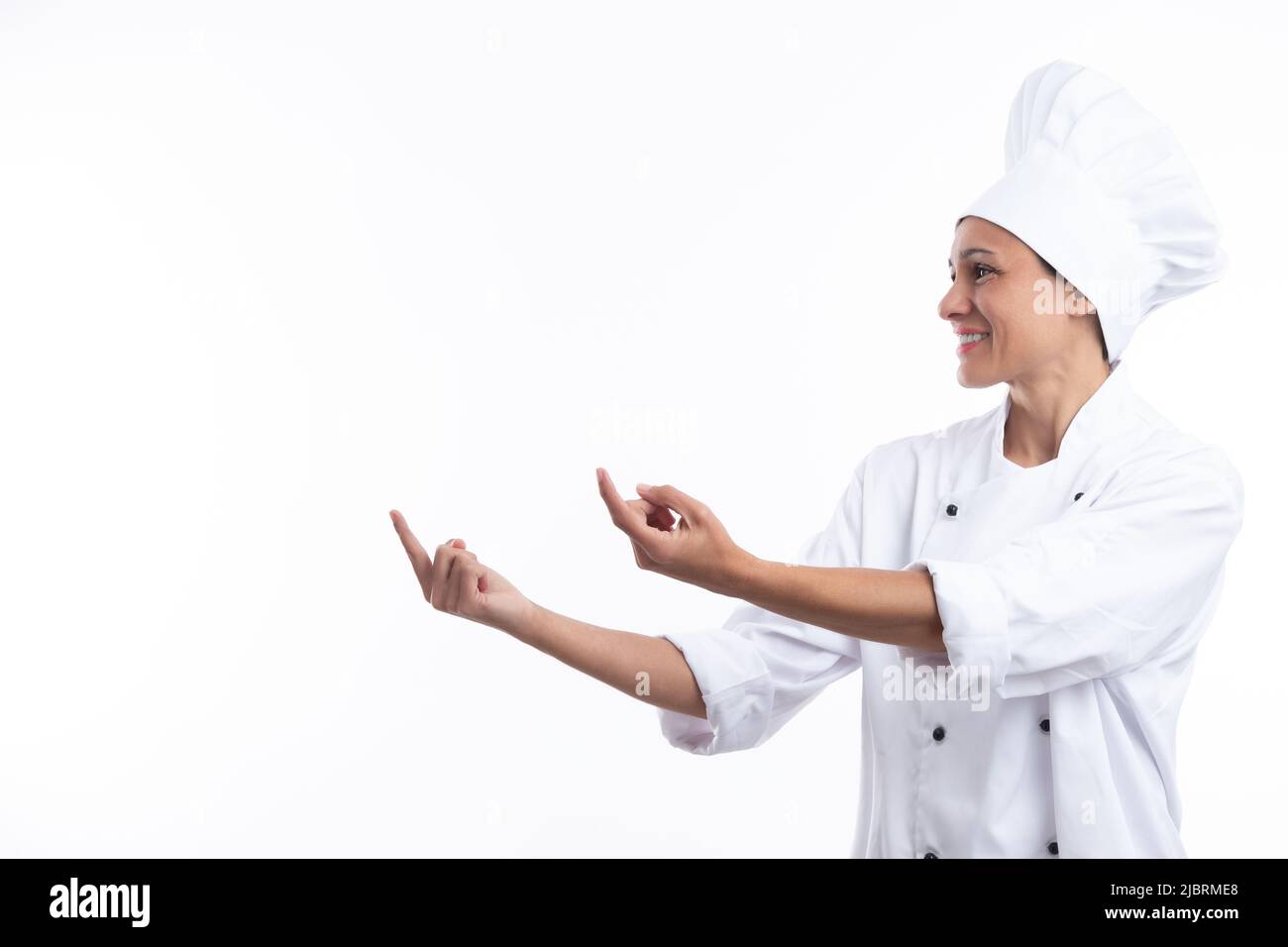 Woman chef pointing with fingers isolated on white background with copy ...