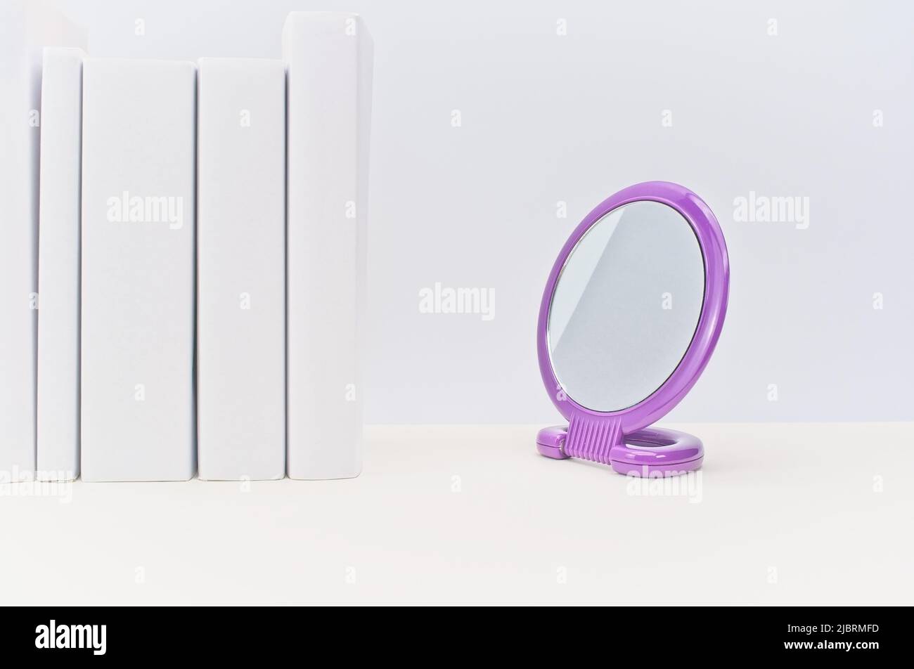 round table mirror with plastic frame on a soft beige desk Stock Photo ...