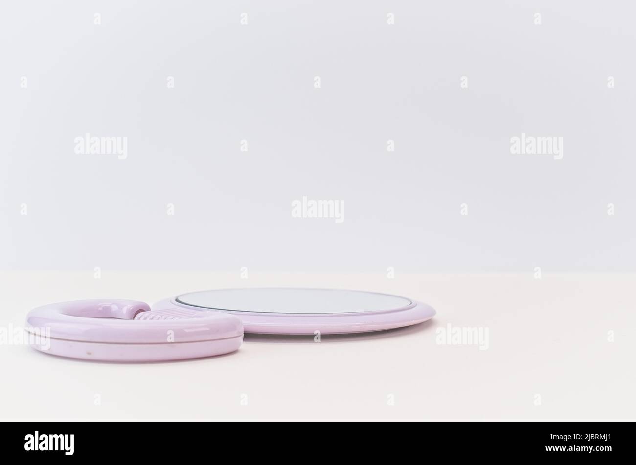 round table mirror with plastic frame on a soft beige desk Stock Photo ...