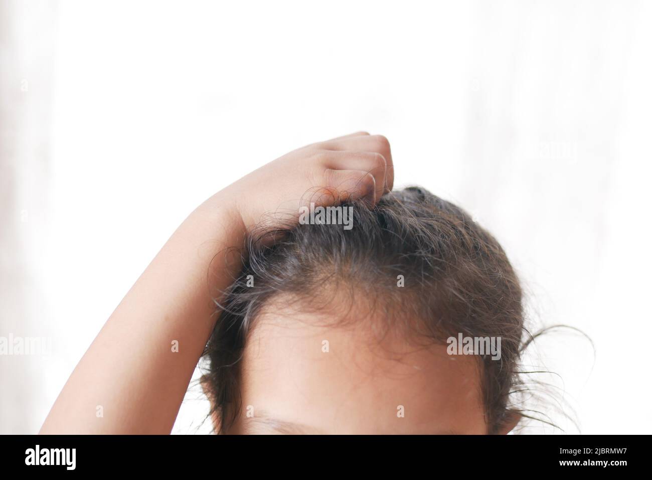 child Scratching Head Against white background Stock Photo - Alamy