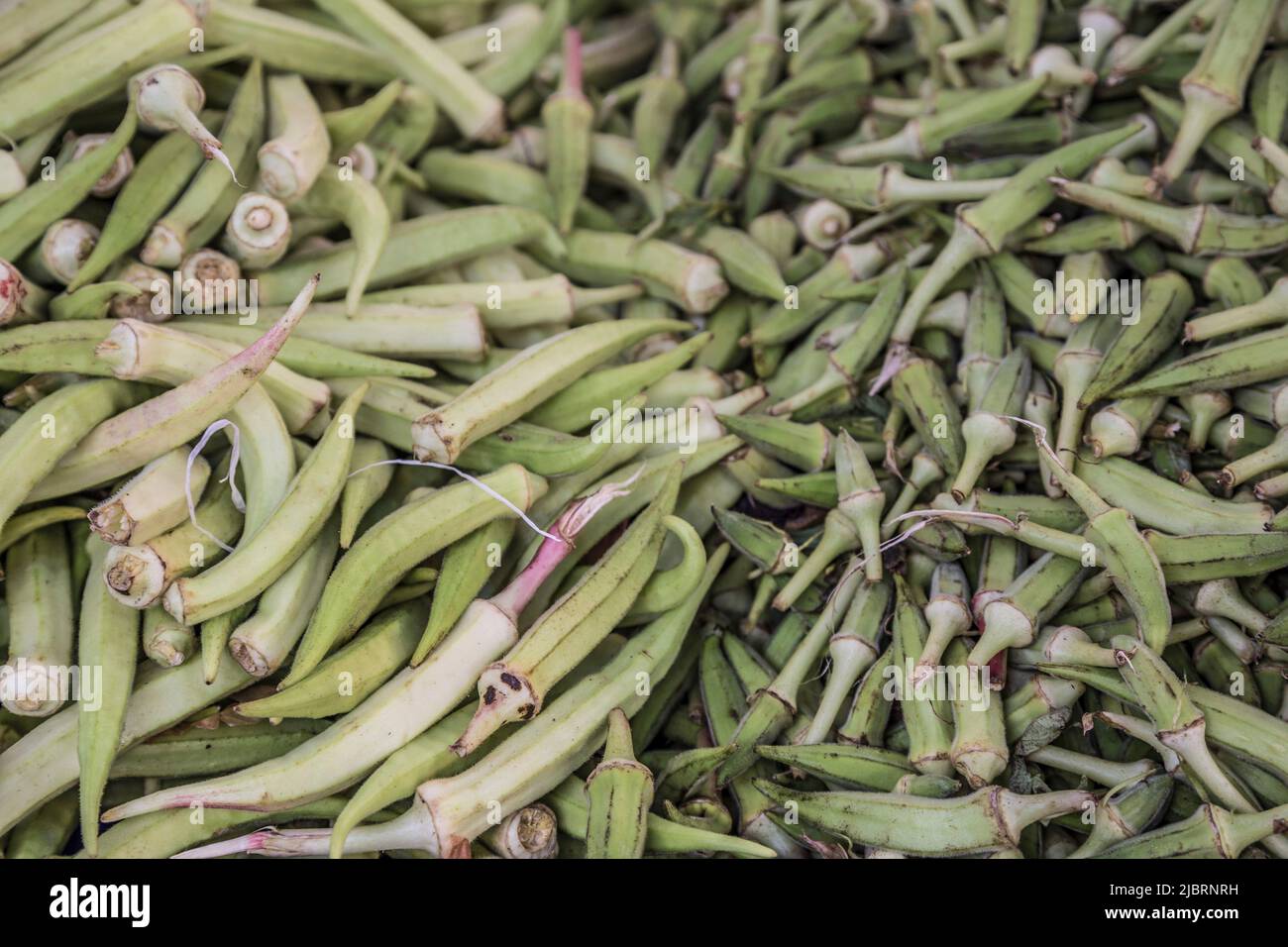 some fresh raw okras as a background Stock Photo - Alamy