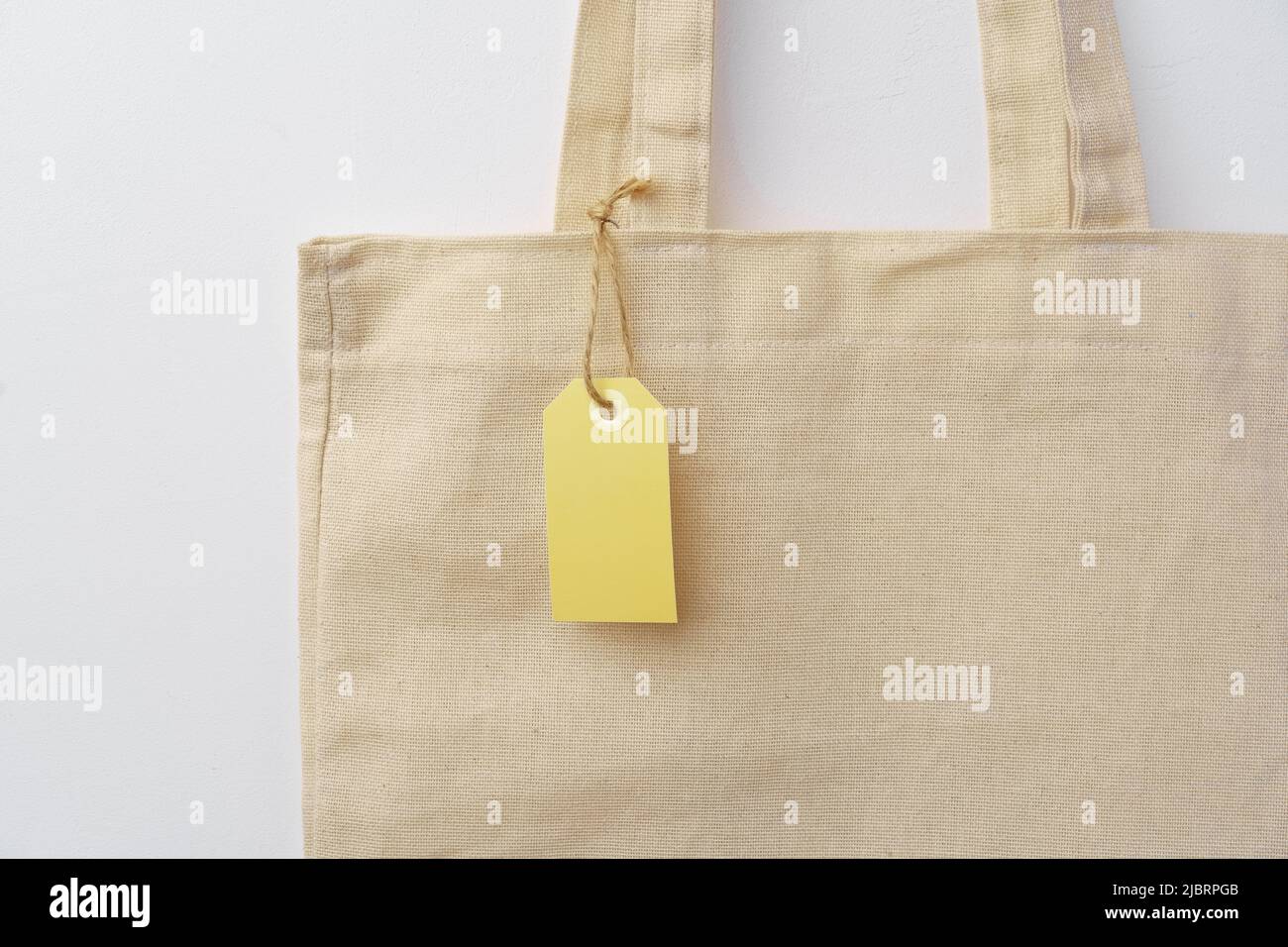 Eco bag for shopping with blank tag on white background Stock Photo - Alamy