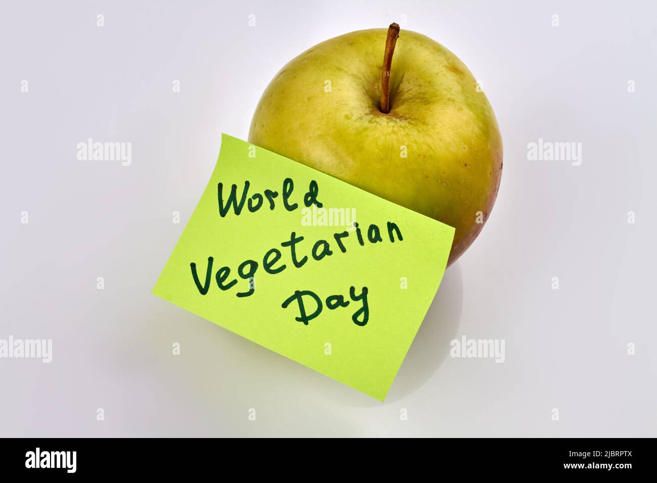 Green ripe apple with sticker note isolated on white background. World ...