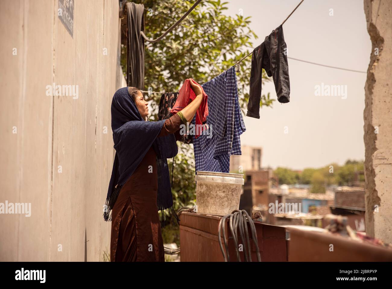 Woman hanging up washing hi-res stock photography and images - Alamy