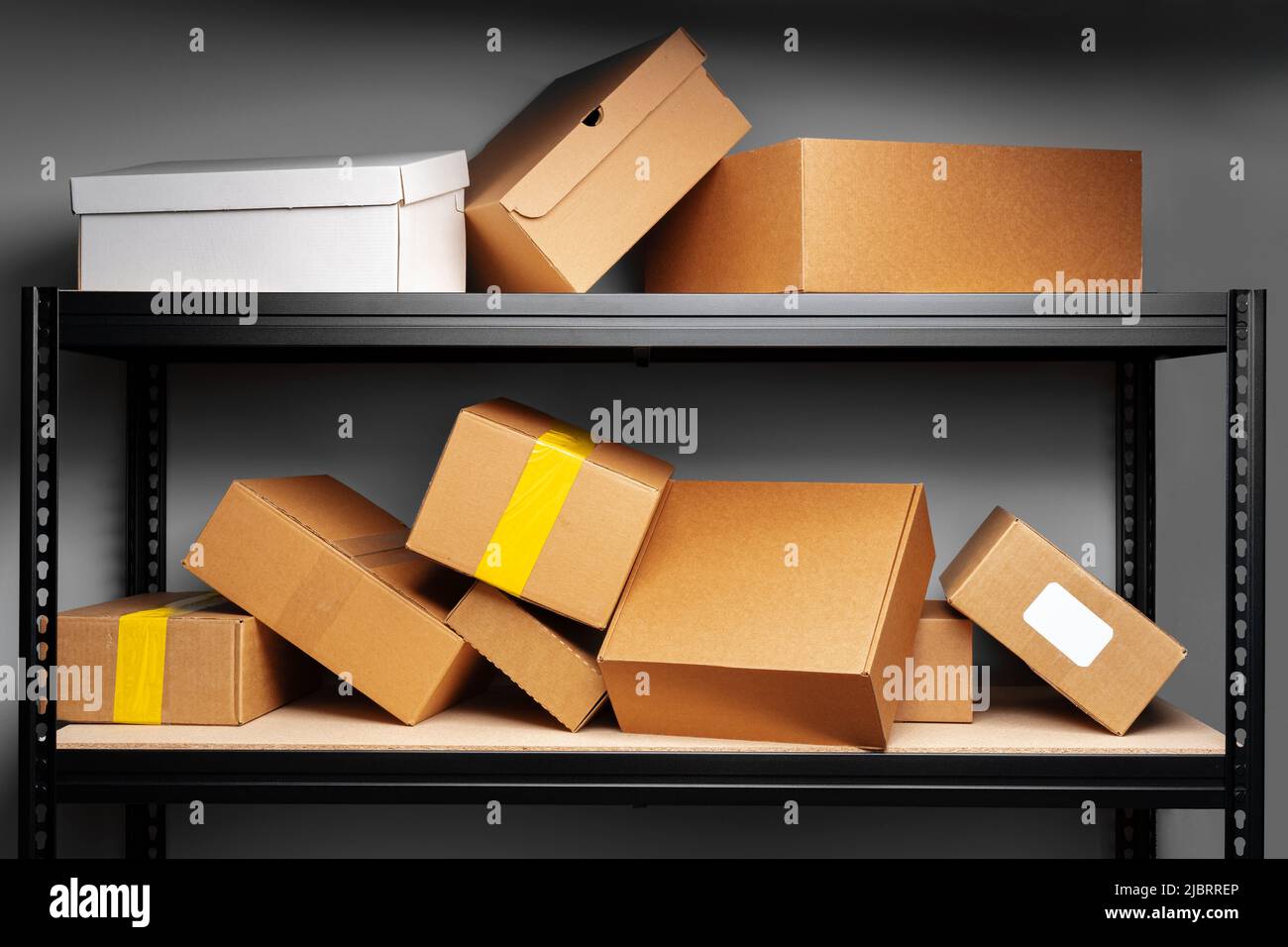 Rows of shelves with cardboard boxes in modern warehouse Stock Photo ...