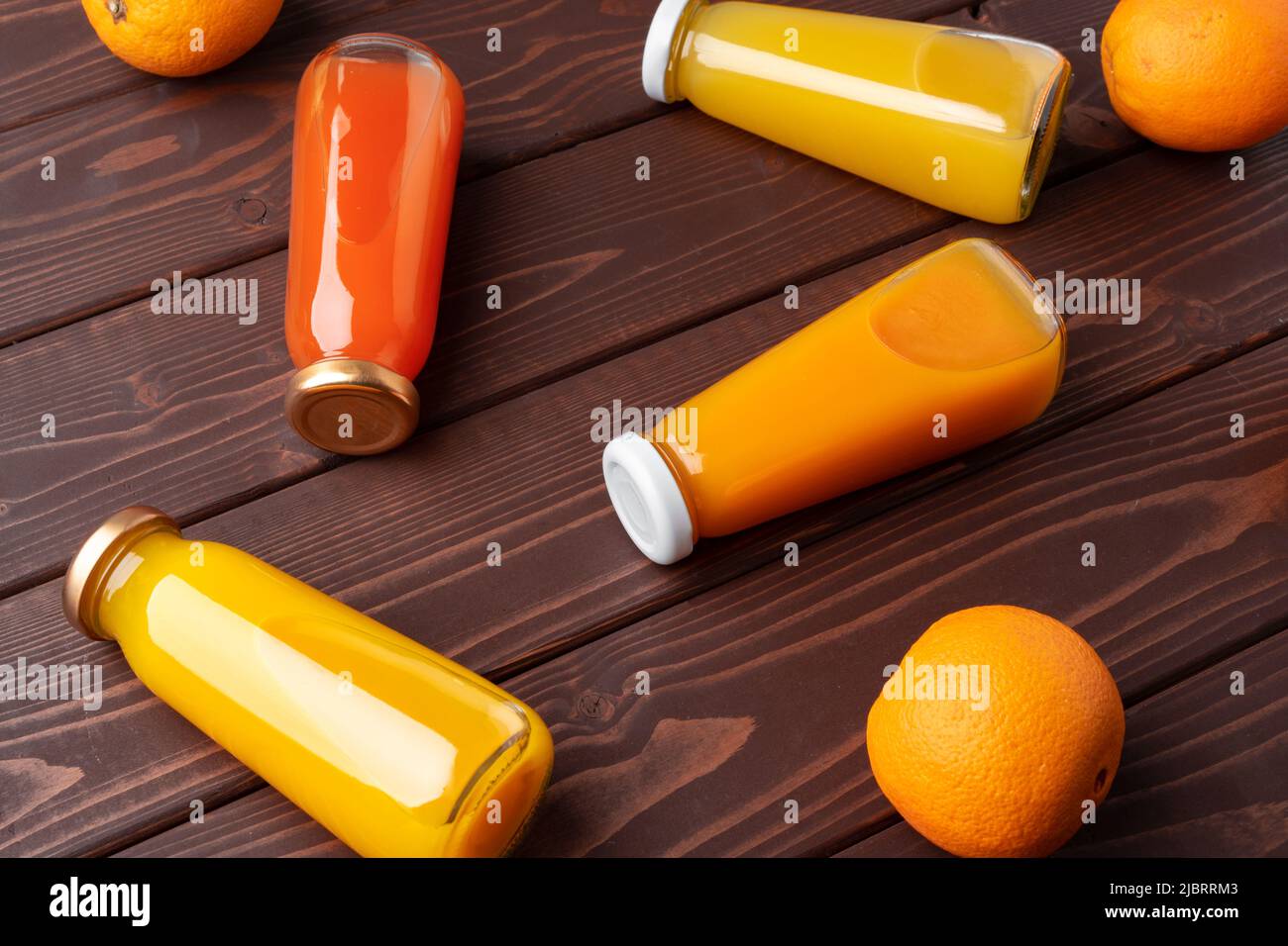 Fresh orange juice in the glass with orange fruit on wooden background ...