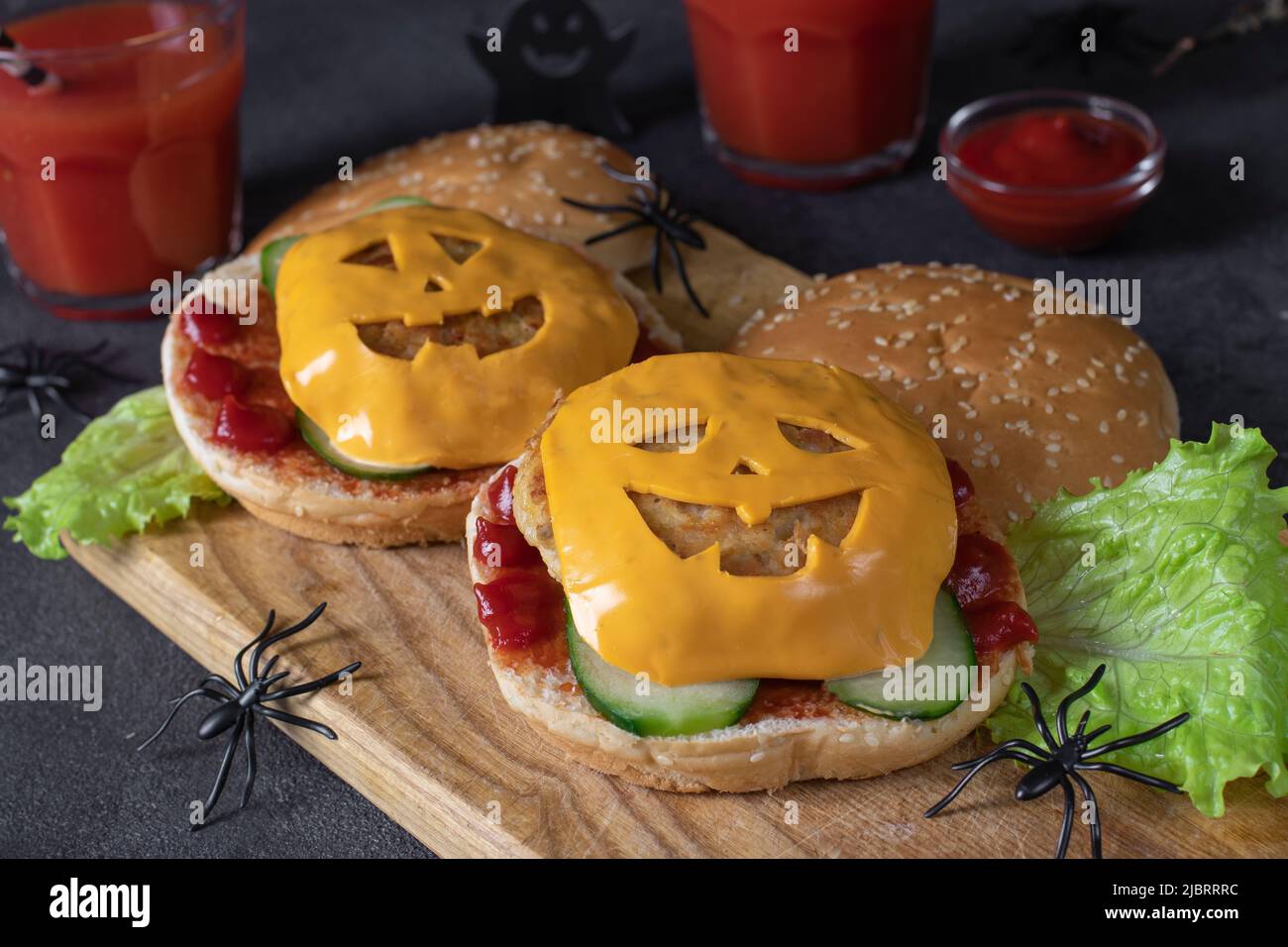 Two funny monster chicken burgers with toast cheese, ketchup and ...