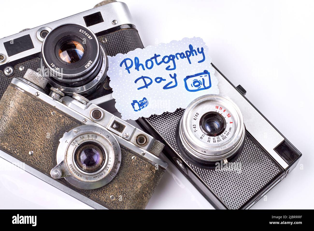 Close-up collection of photo cameras isolated on white background. Top ...