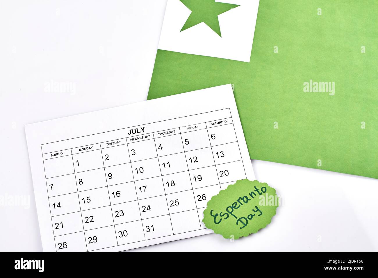 Flat lay calendar and esperanto flag with a star. Esperanto day concept ...