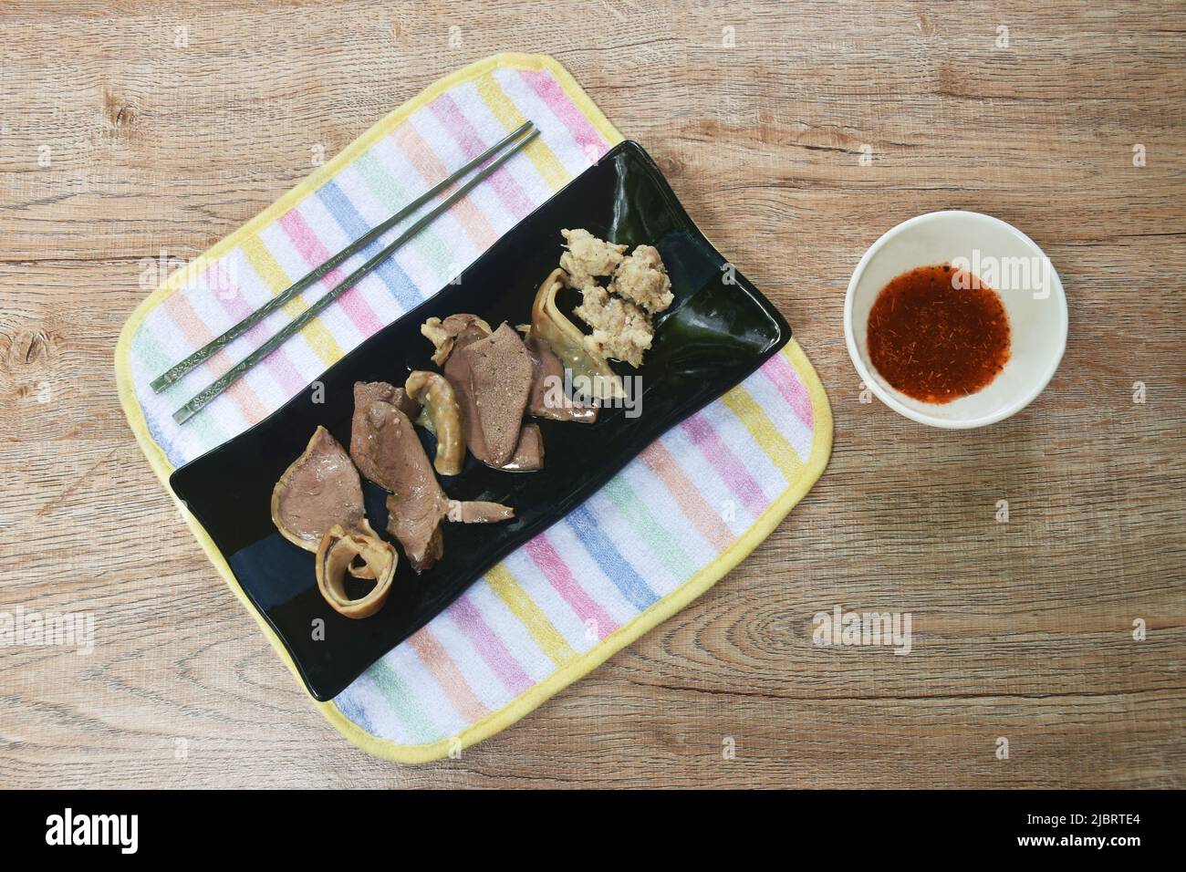 boiled entrails with chop pork on plate dipping spicy and sour chili ...