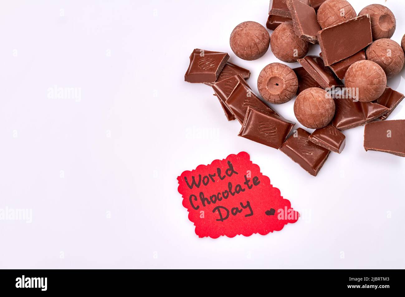 Pile of many various chocolate pieces on white background. World ...