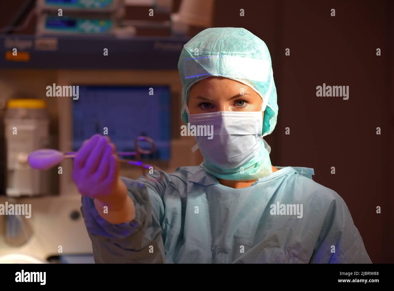 A woman is seen in a hospital operation theater. She is fully dressed ...