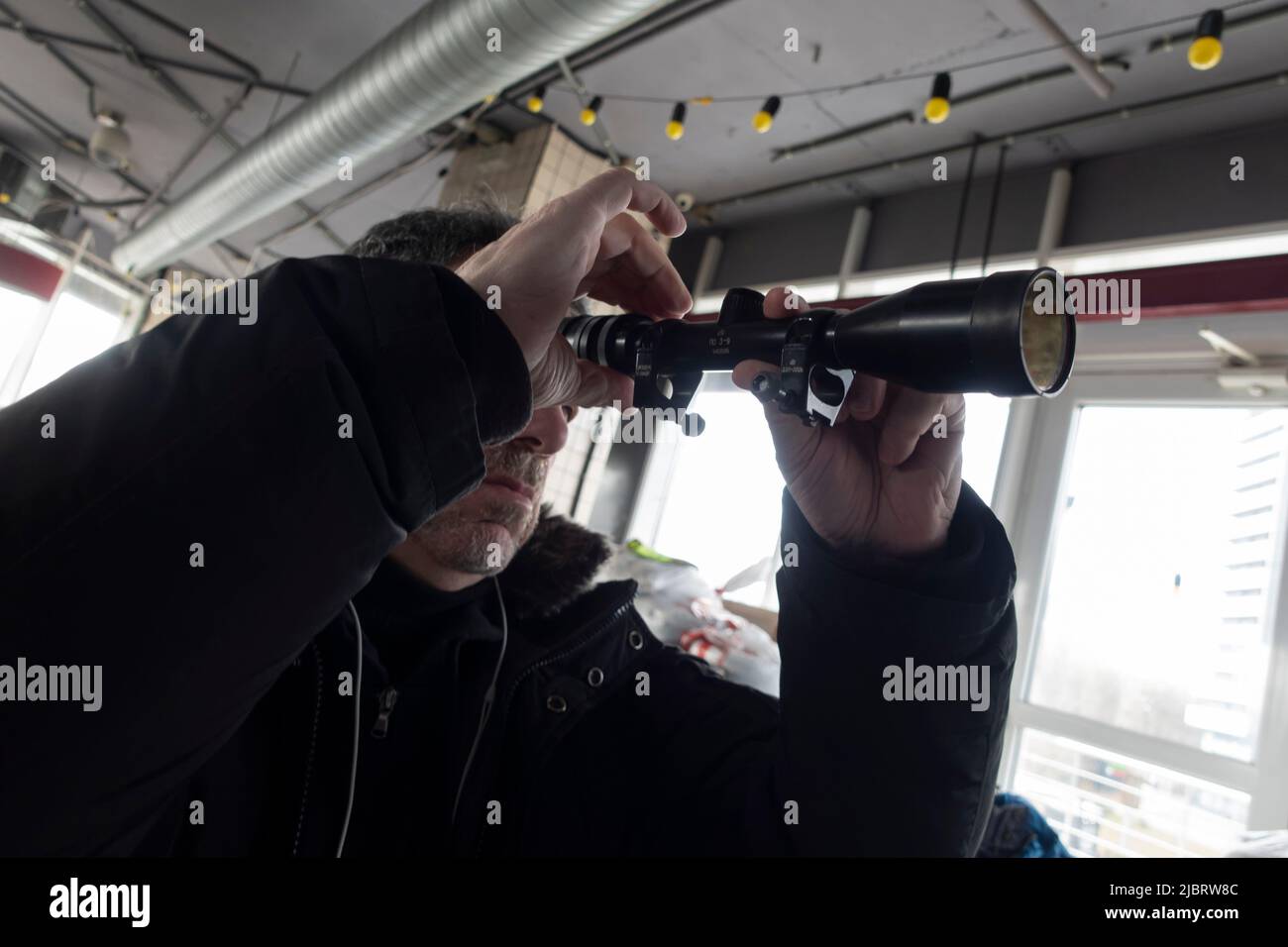 Sniper calibrates scope on rifle hi-res stock photography and images ...