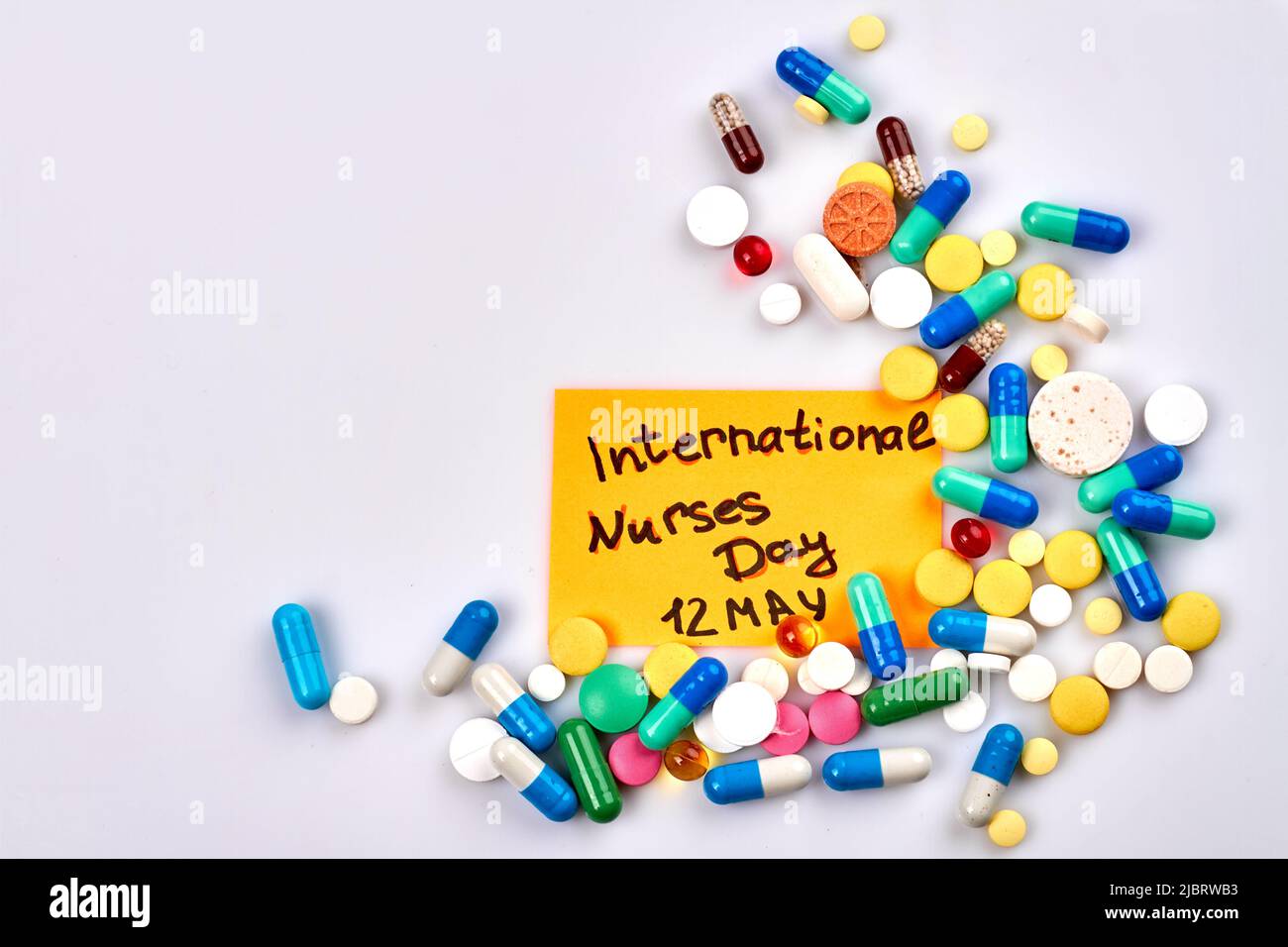International nurse day and pile of many various pills. Isolated on ...
