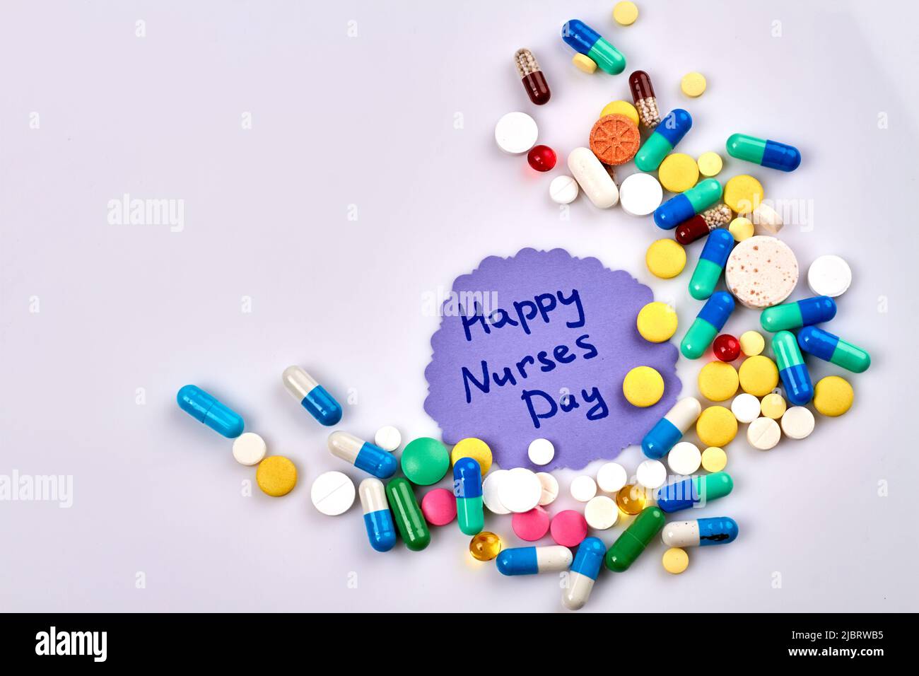 Happy nurses day and many various pills on white background. Top view ...