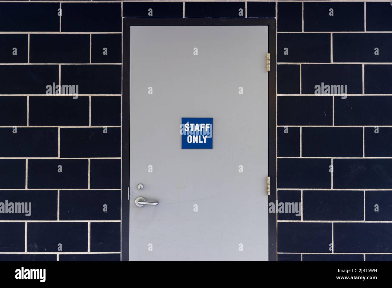 Staff only sign. Area for staff. Brick wall background Stock Photo - Alamy