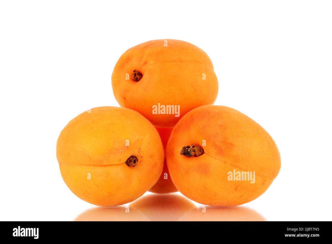 Three ripe sweet apricots, close-up, isolated on a white background ...