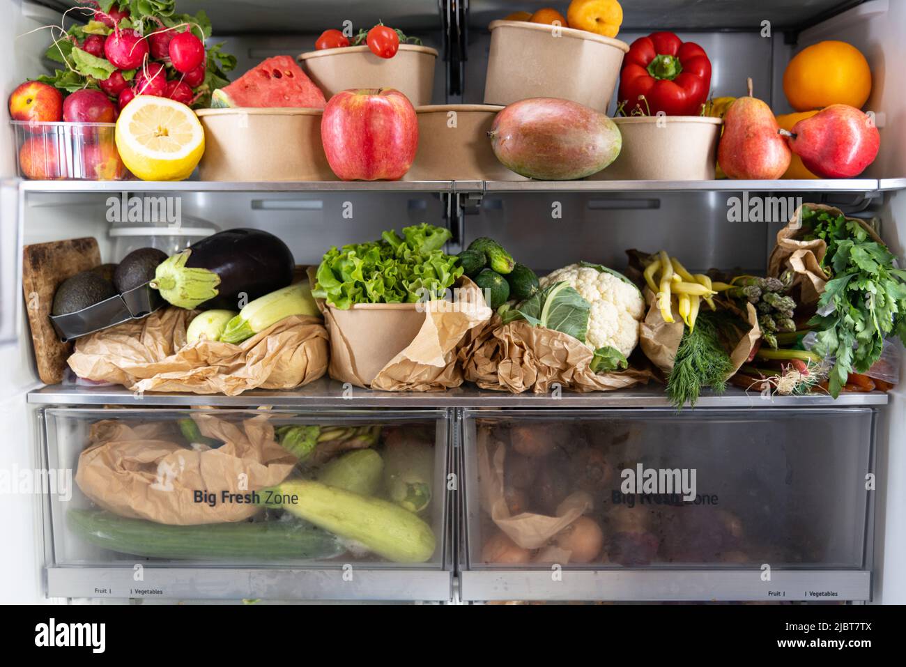 Opened refrigerator full of vegetarian healthy fresh fruit, vegetables ...