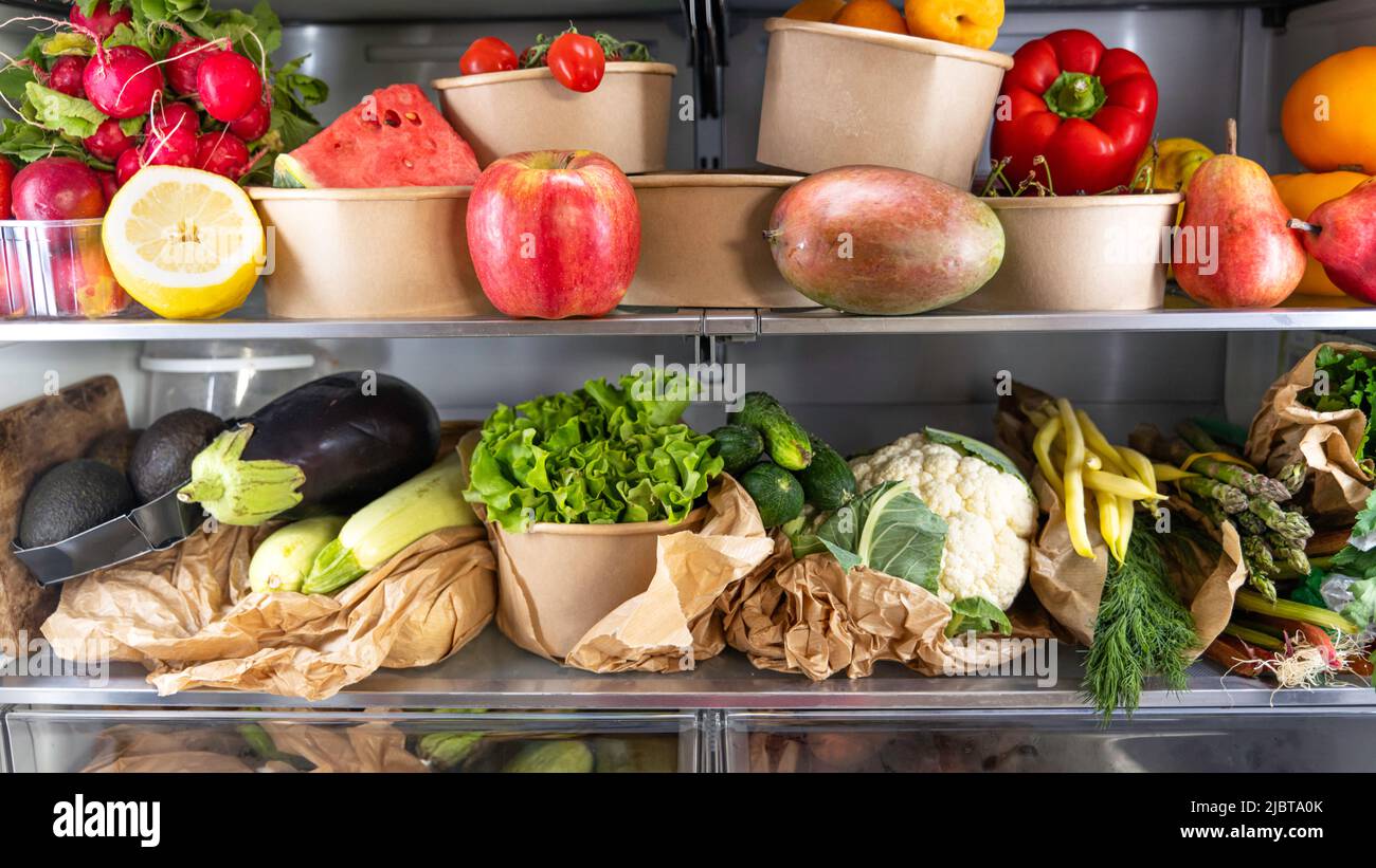 Opened refrigerator full of vegetarian healthy fresh fruit, vegetables ...