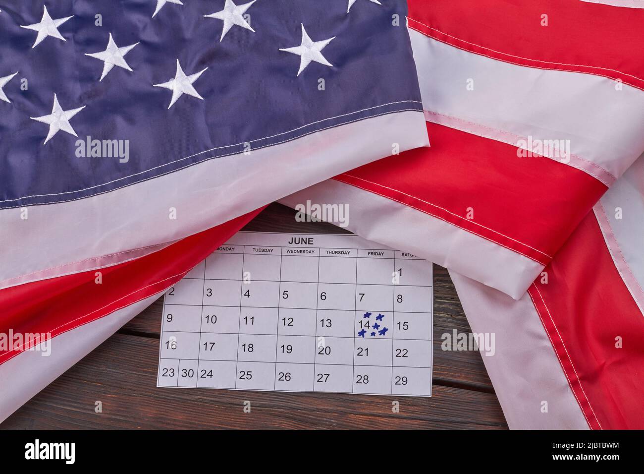 United states flag with calendar with marked june 14th. Top view flat ...