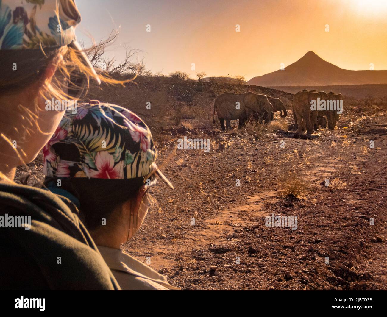 Namibia, Kunene region, Damaraland, Bergsig, 2 young girls observe, on ...