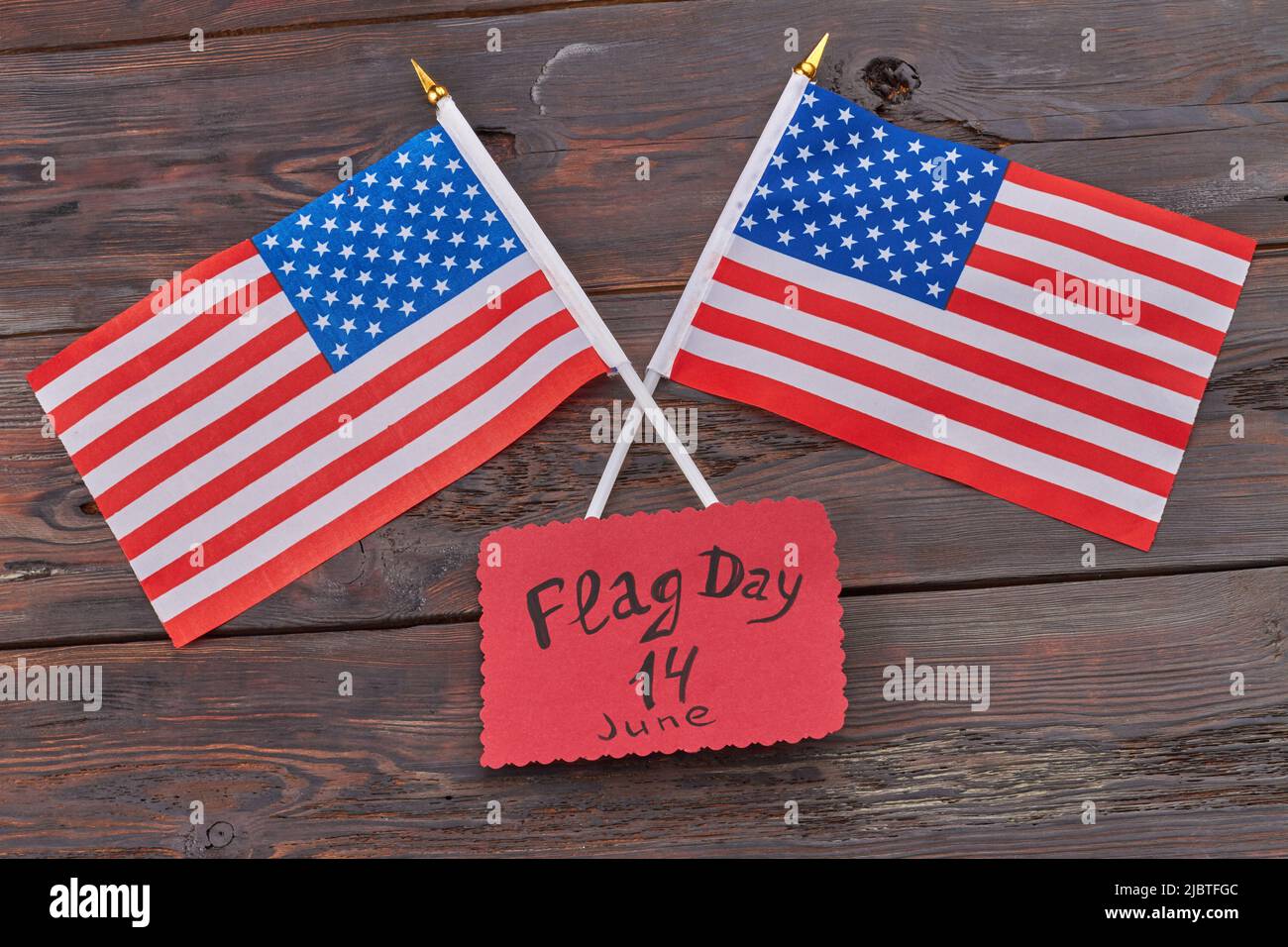 Flat lay top view flag day 14th june concept. Two US flags on wooden ...