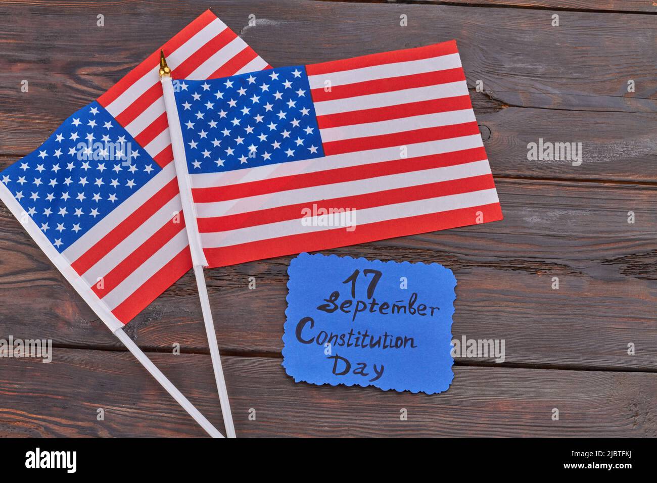 Two wave flags of the United States on woodek desk. 17 september ...