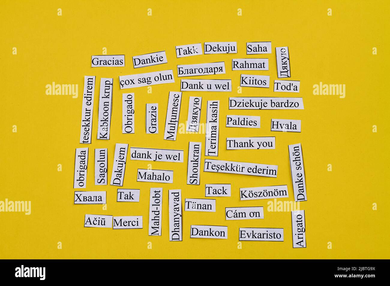 Papers with thank you in many different languages. Isolated on yellow ...