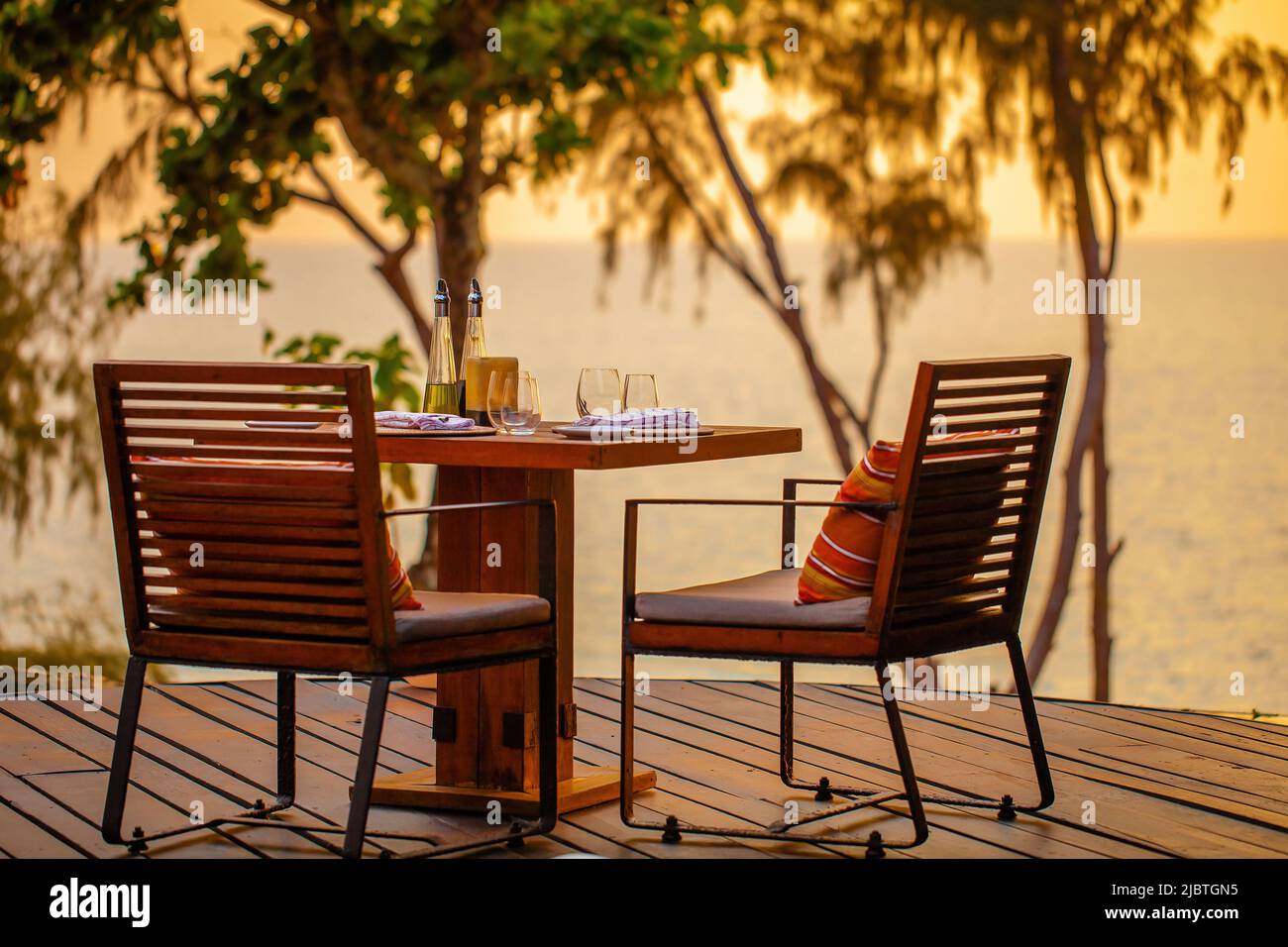 Sea sunset in modern luxury restaurant with terrace. Luxury hotel or ...