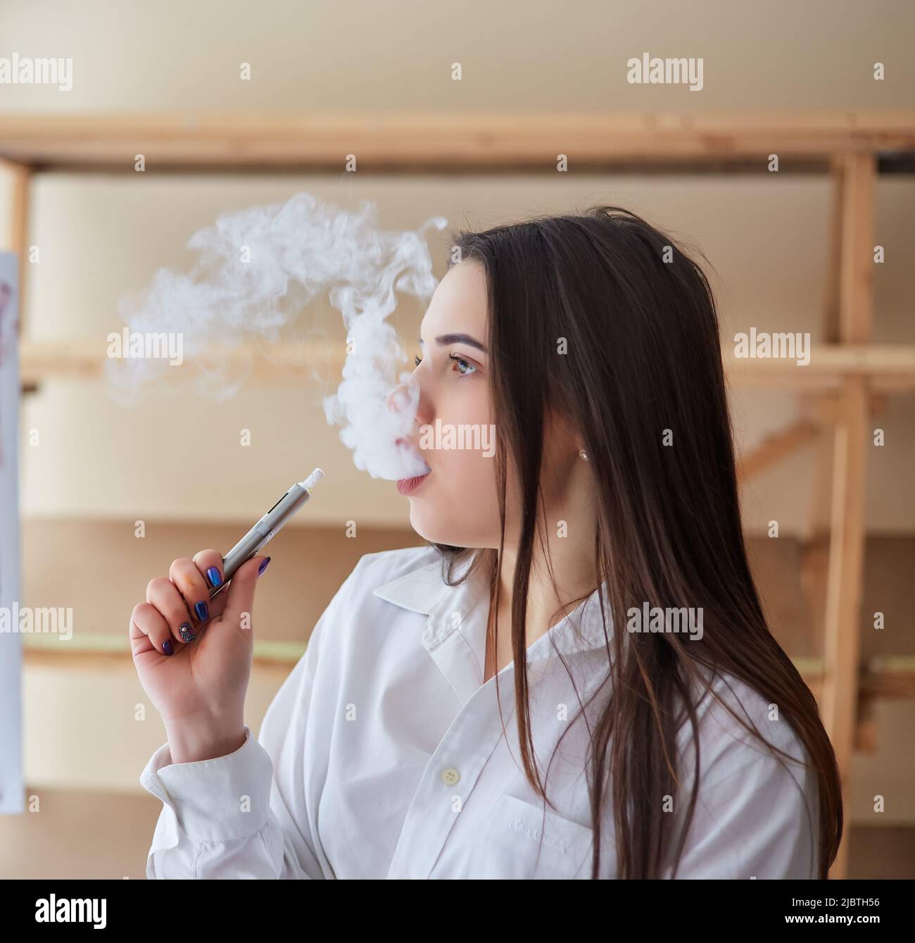 Modern girl smoking vape.Trendy new vaping device,smoke e-liquid ...