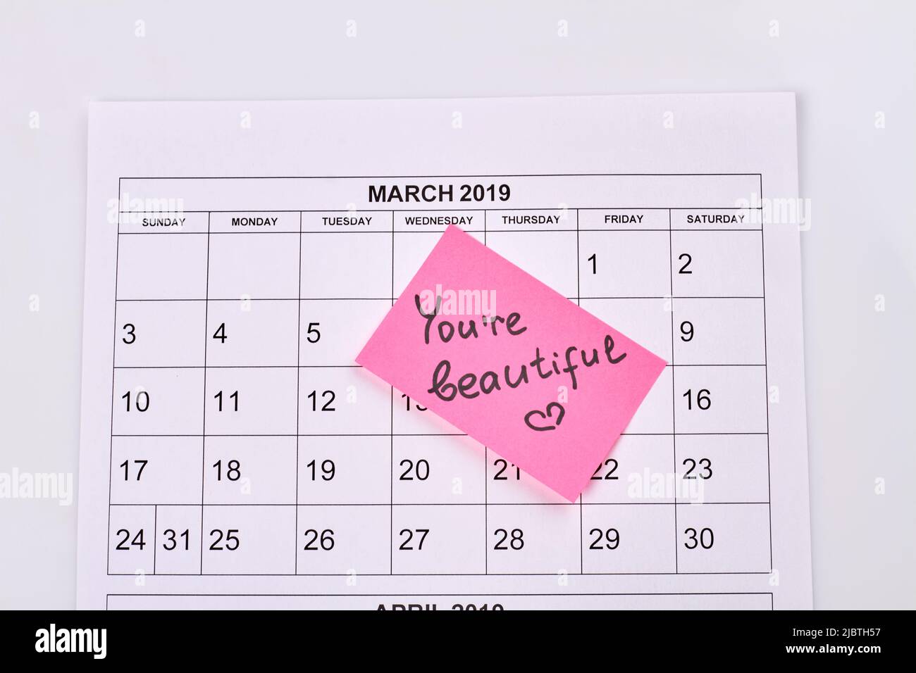 March calendar and sticker note with you are beautiful handwriting. Top ...