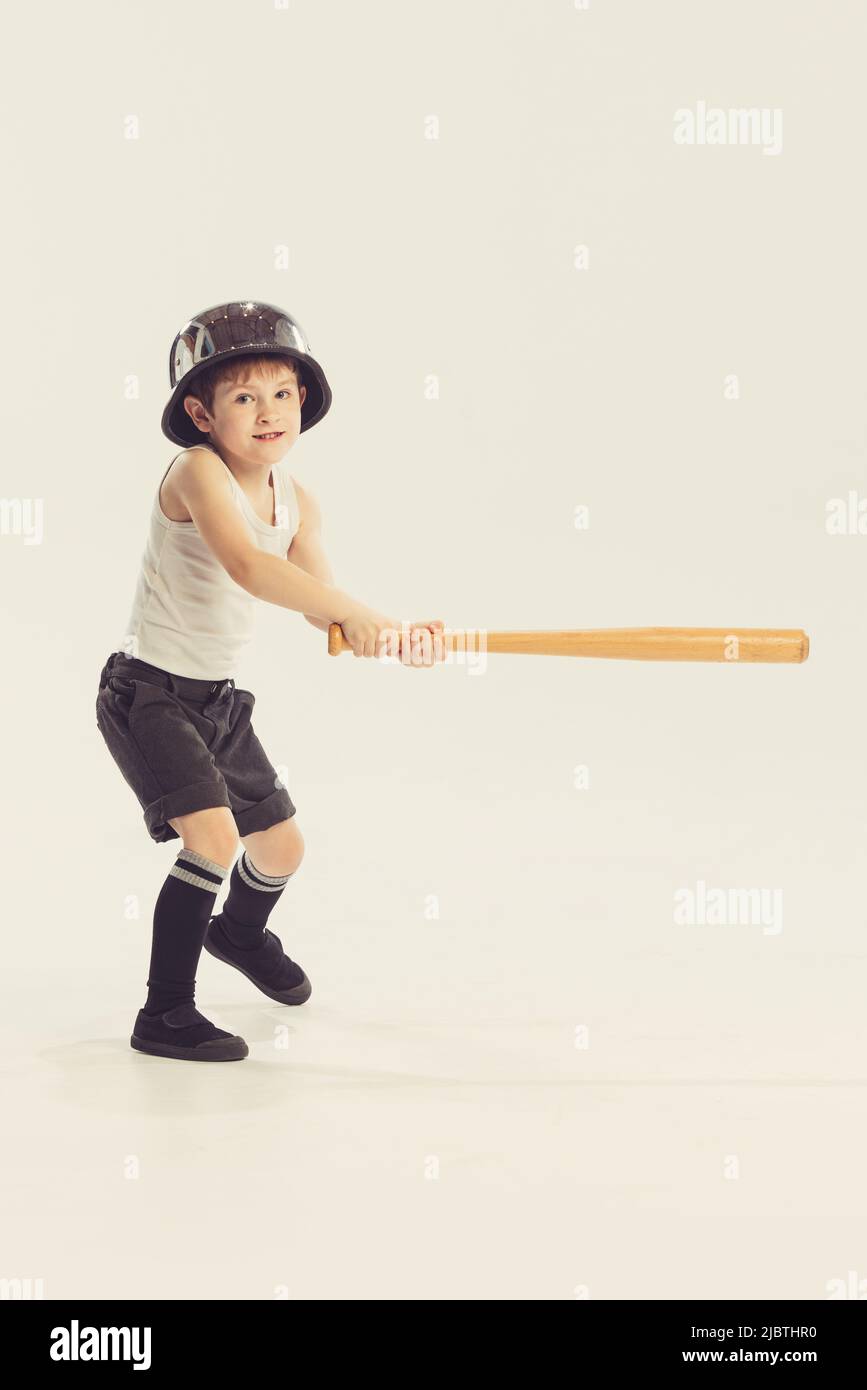 Portrait of little boy, child with bat and helmet posing, playing ...
