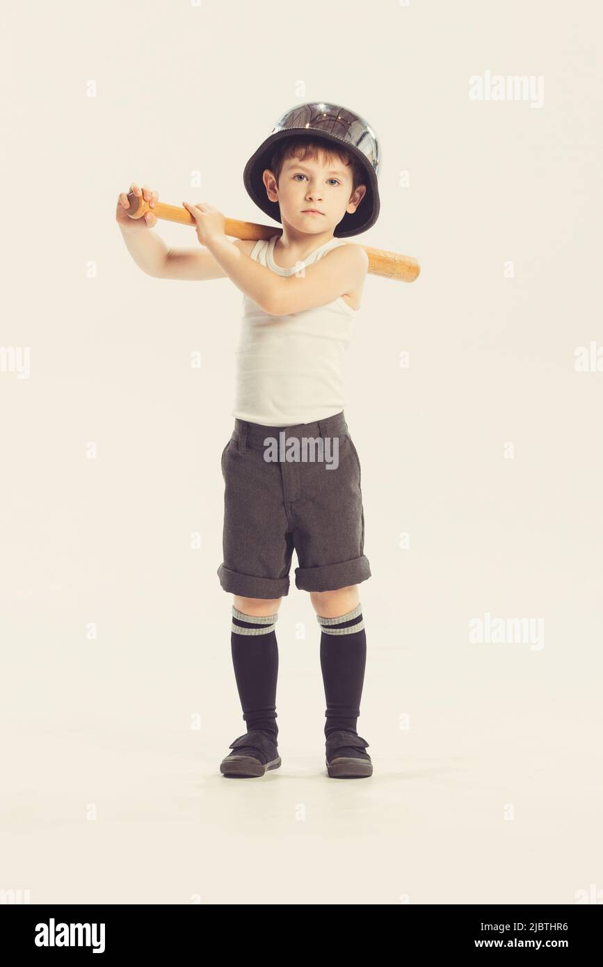 Portrait of little boy, child with bat and helmet posing, playing ...