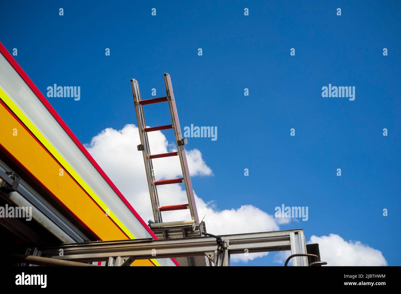 Retractable ladder on a fire engine, against a blue sky Stock Photo - Alamy