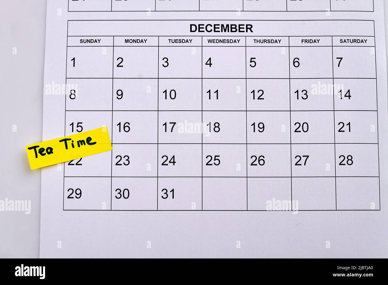 December month calendar and paper with tea time handwriting. Isolated ...