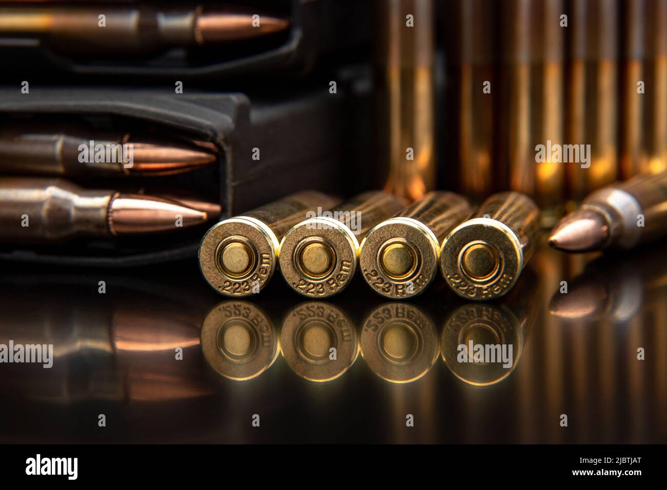 Bullet isolated on black background with reflexion. Rifle bullets close ...