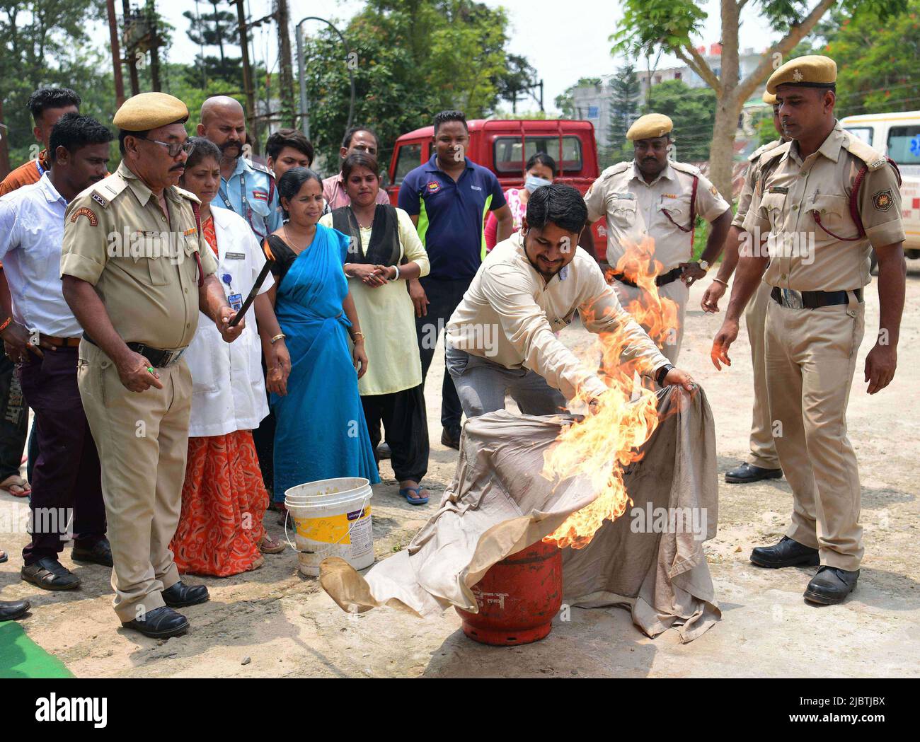 Agartala, India's northeastern state of Tripura. 8th June, 2022. A staff member tries to control ...