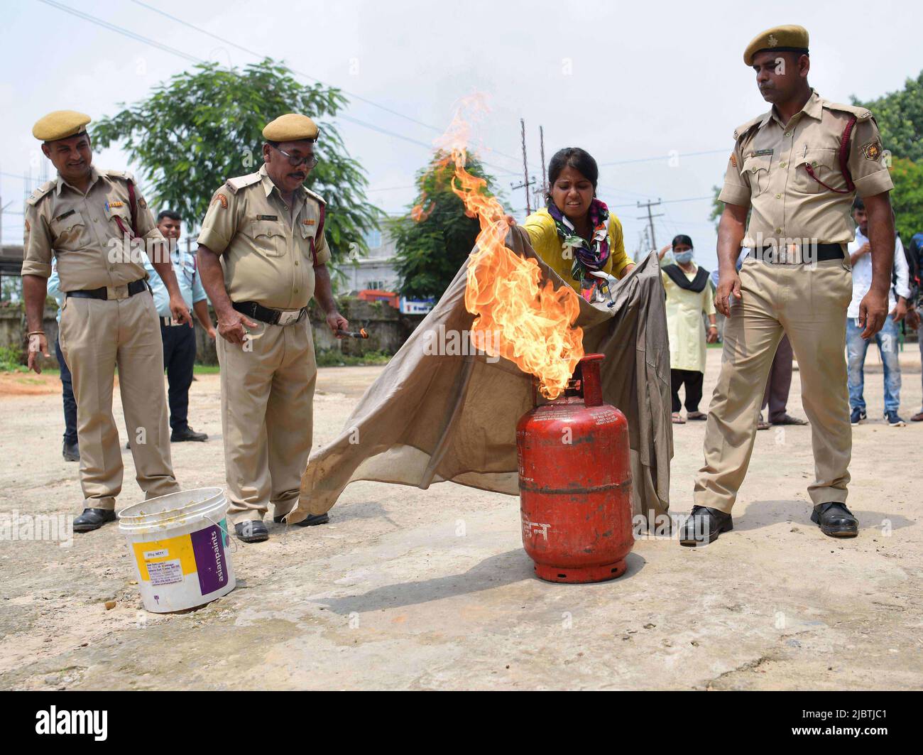 Agartala, India's northeastern state of Tripura. 8th June, 2022. A staff member tries to control ...