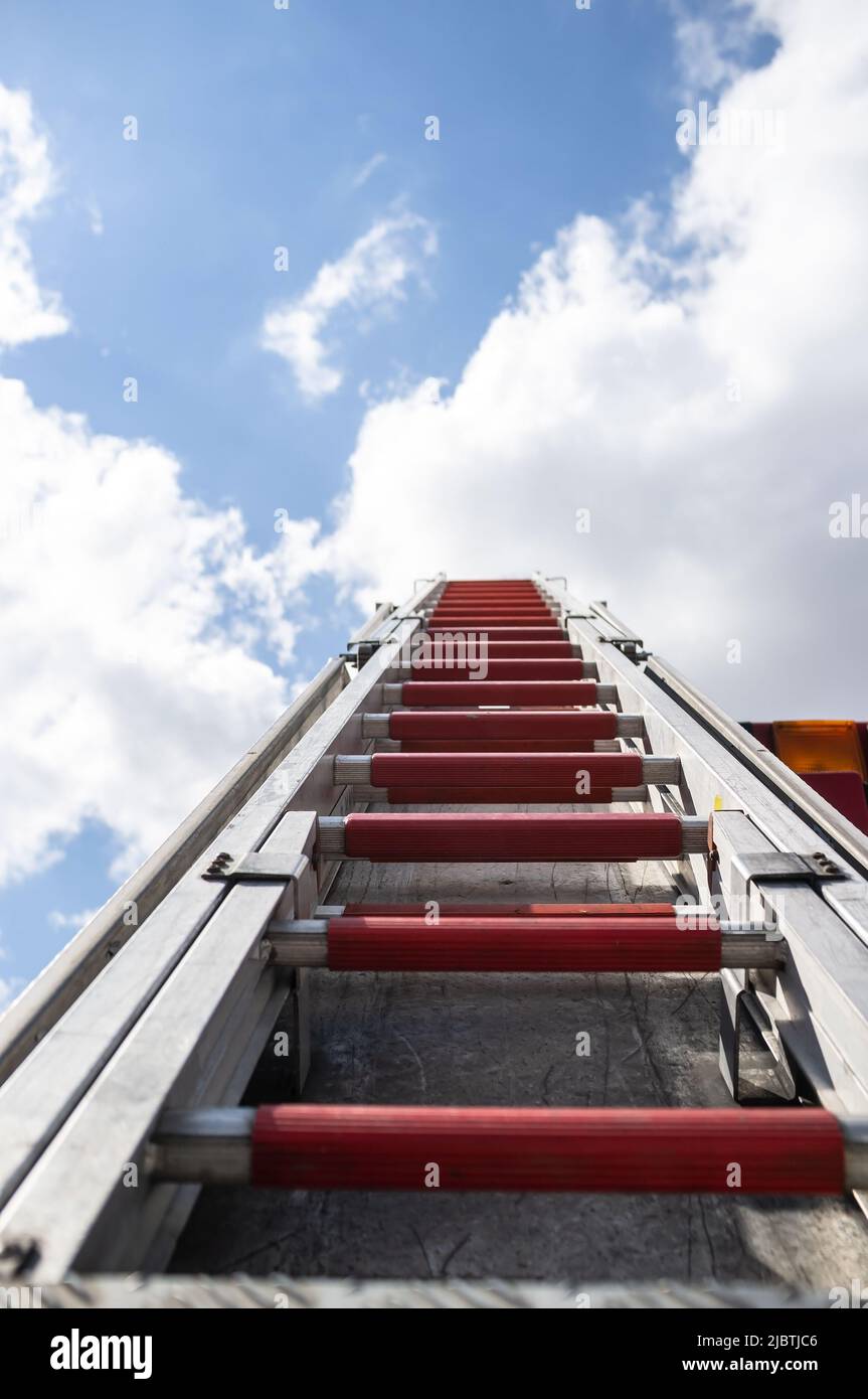 Retractable ladder on a fire engine, against the background of a blue ...